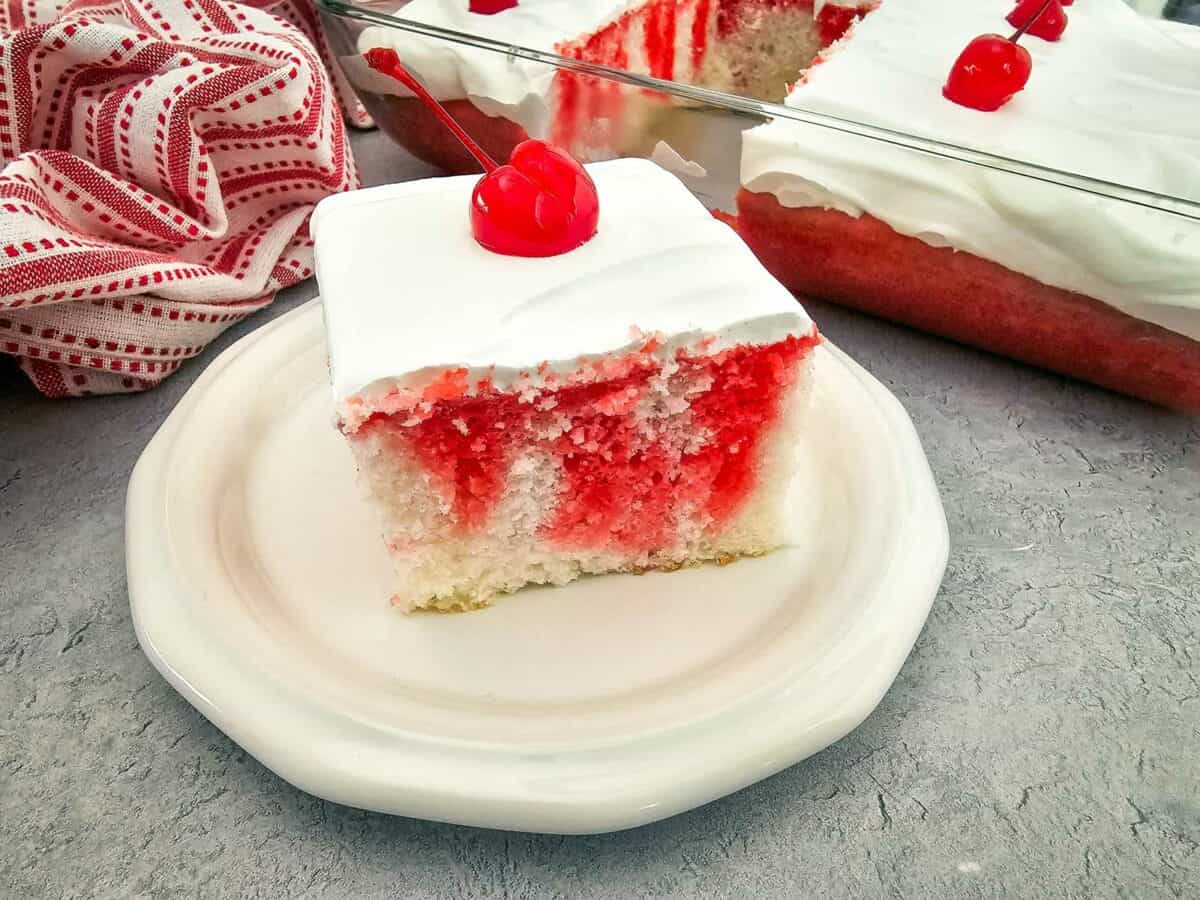 Cherry Jello Poke Cake Recipe With Dream Whip frosting · Artsy Fartsy Life
